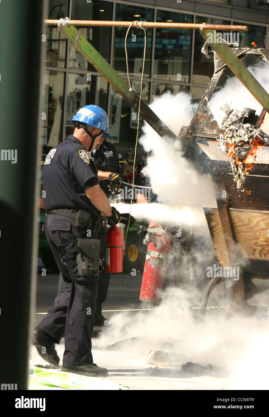 Aug 29, 2004; New York, NY, USA; Police extinguish a float set on fire ...