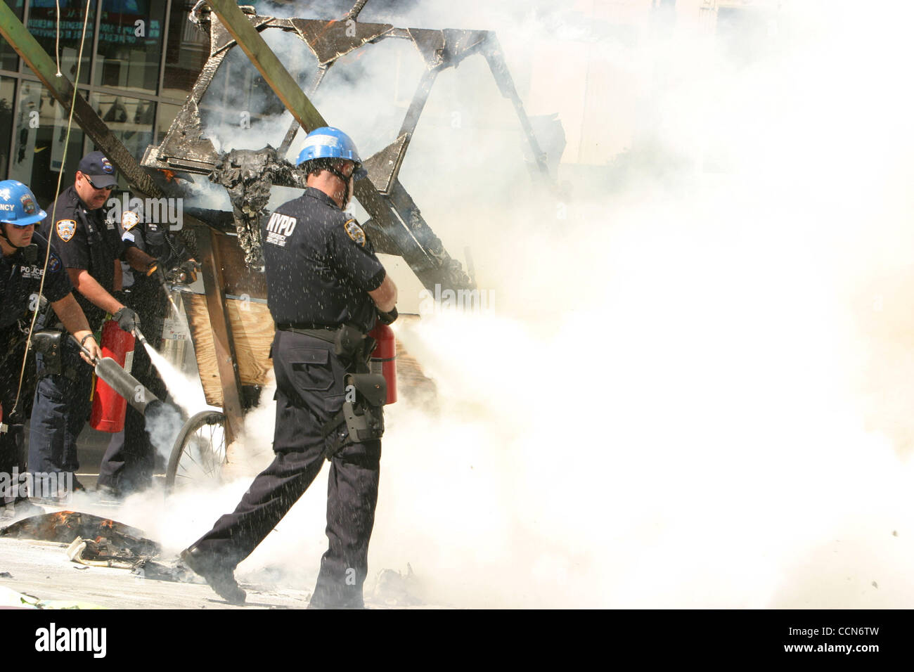 Aug 29, 2004; New York, NY, USA; Police extinguish a float set on fire ...