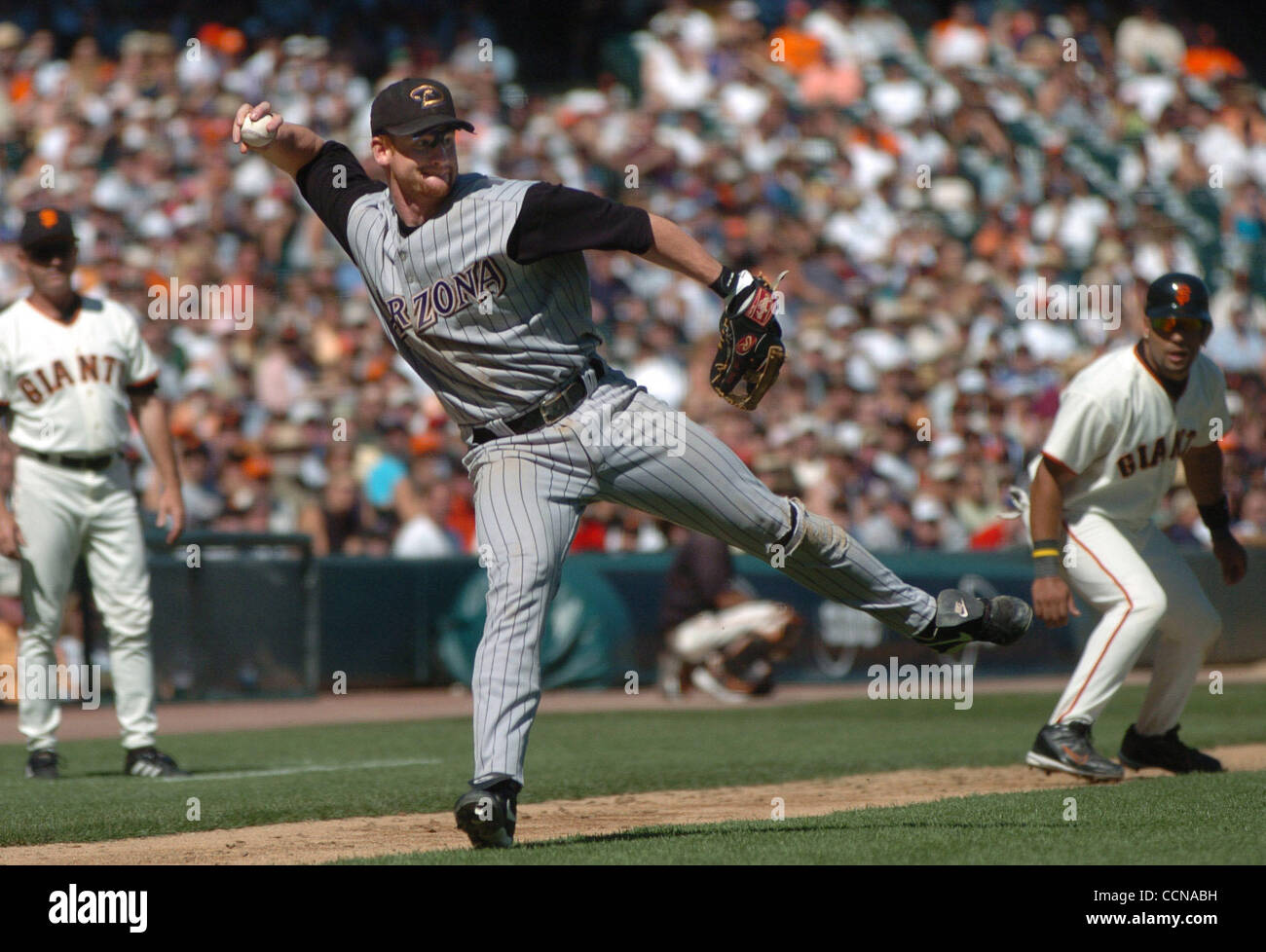 Diamondback 3rd baseman Chad Tracy fields a slow roller off the bat of ...