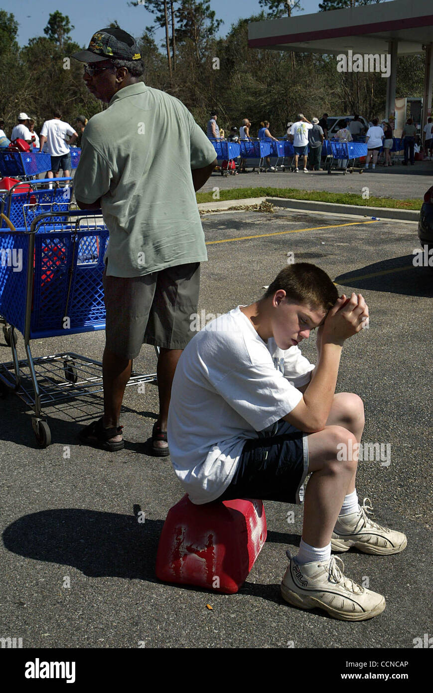 091804 met ivan--Pensacola--Justin Joslin, 14, waits on a five gallon ...
