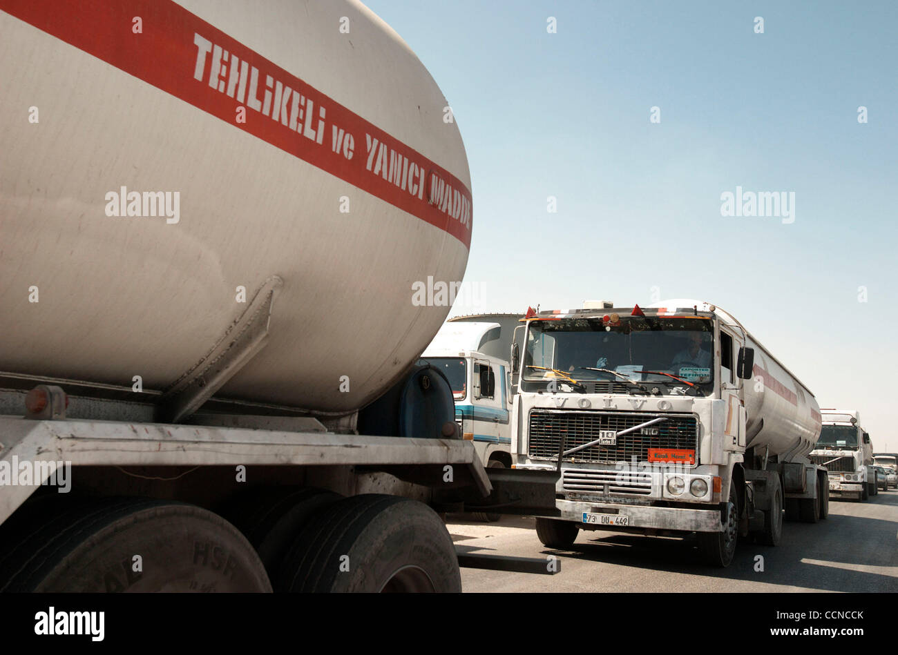 Turkish trucks stream into and out of Iraq near the Turkish border at ...