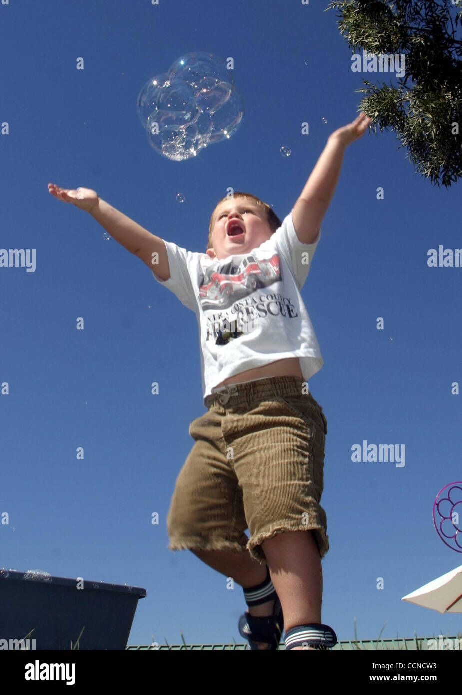 Jack McClellan (cq), 2 years-old, chases a bubble made by his dad Dan ...