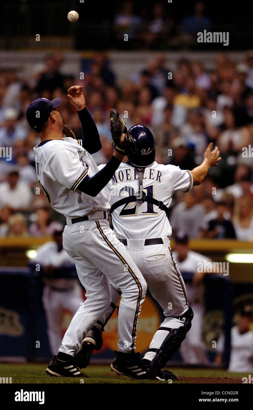 Milwaukee Brewers pitcher Doug Davis, #49, bumps into catcher Chad ...