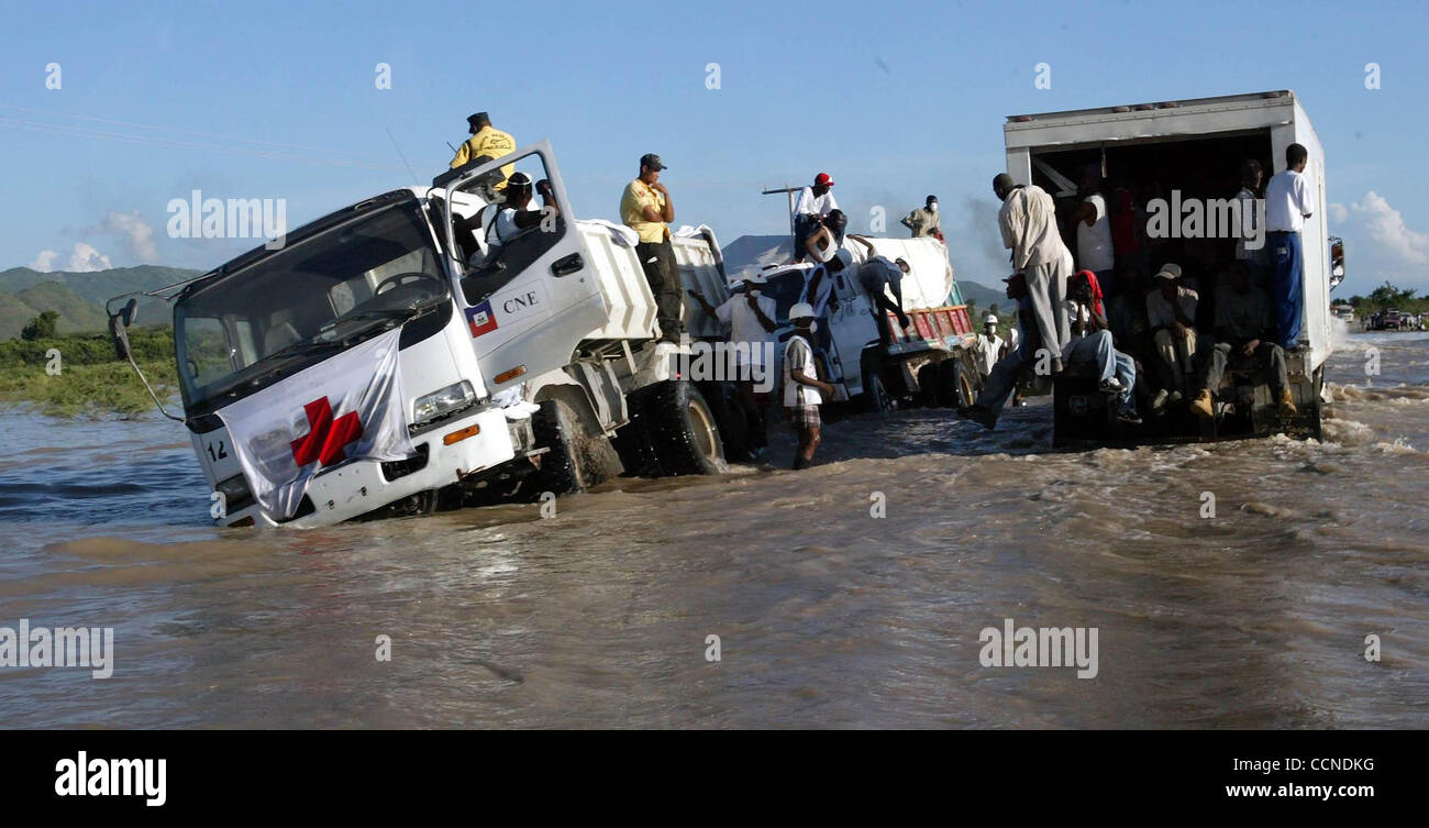 GONAIVES, HAITI; 9/23/04: Two trucks part of a Red Cross convoy sit off ...