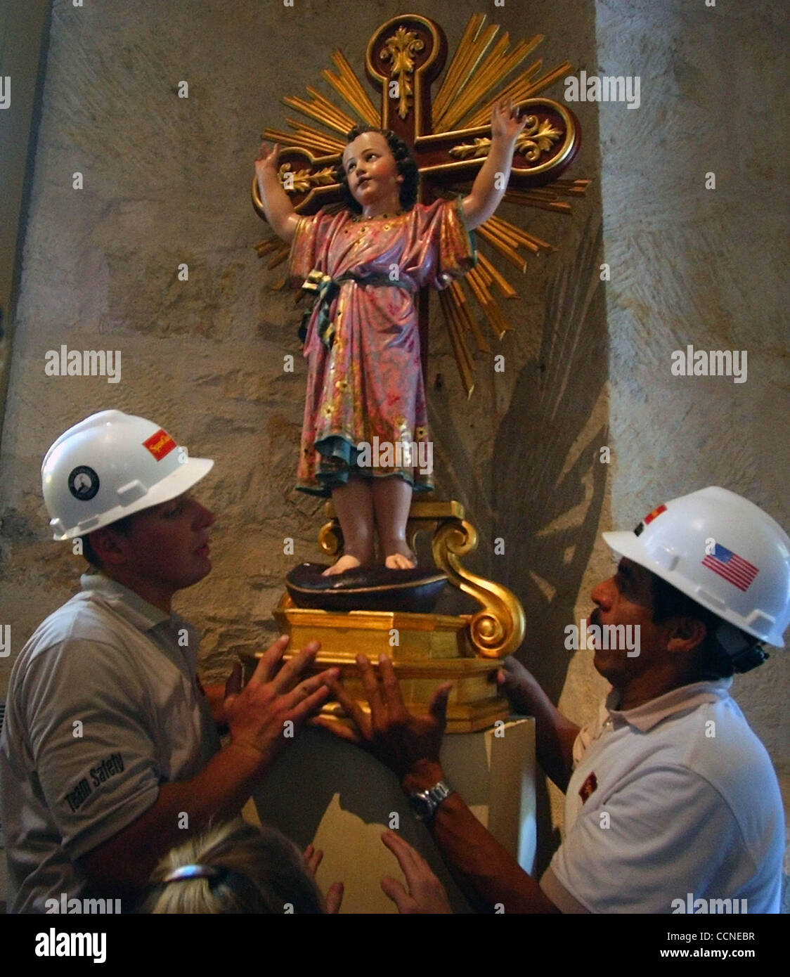 METRO - Workers from Spaw Glass install a restored statue of the Nino ...