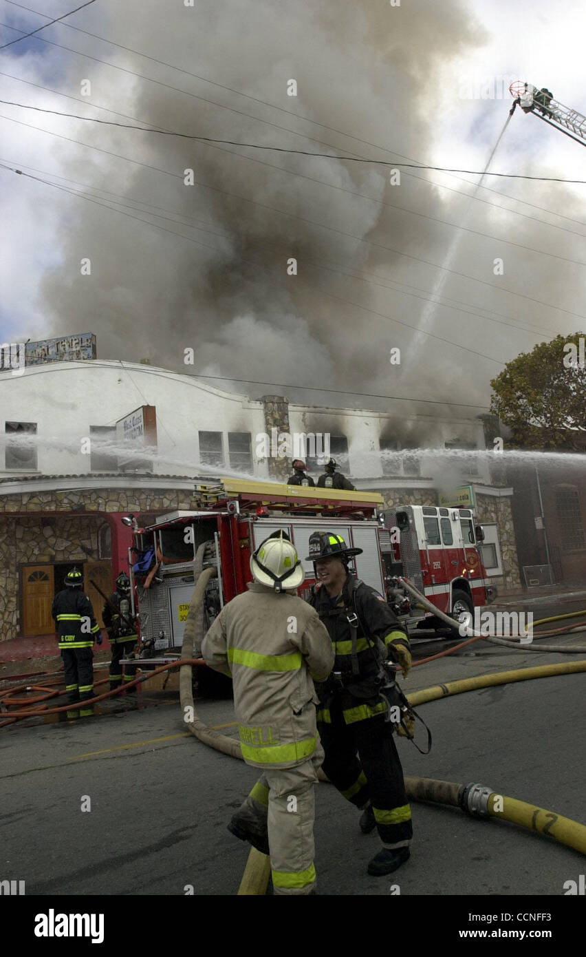 An Oakland Fire Department battalion chief and firefighter stand in ...