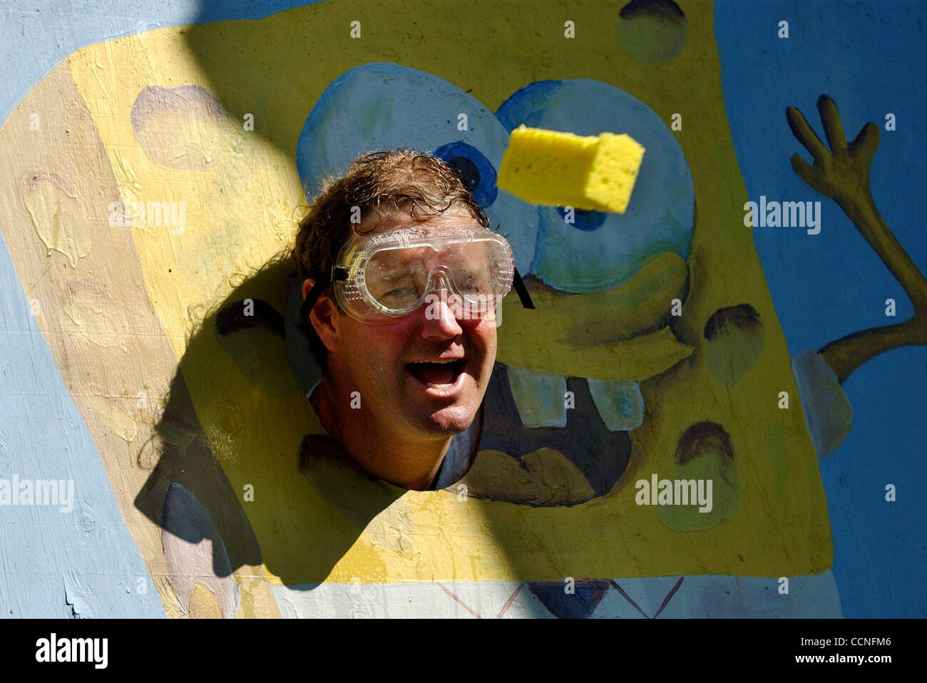 Parent volunteer Brian Briggs gets a wet sponge to the head at the ...