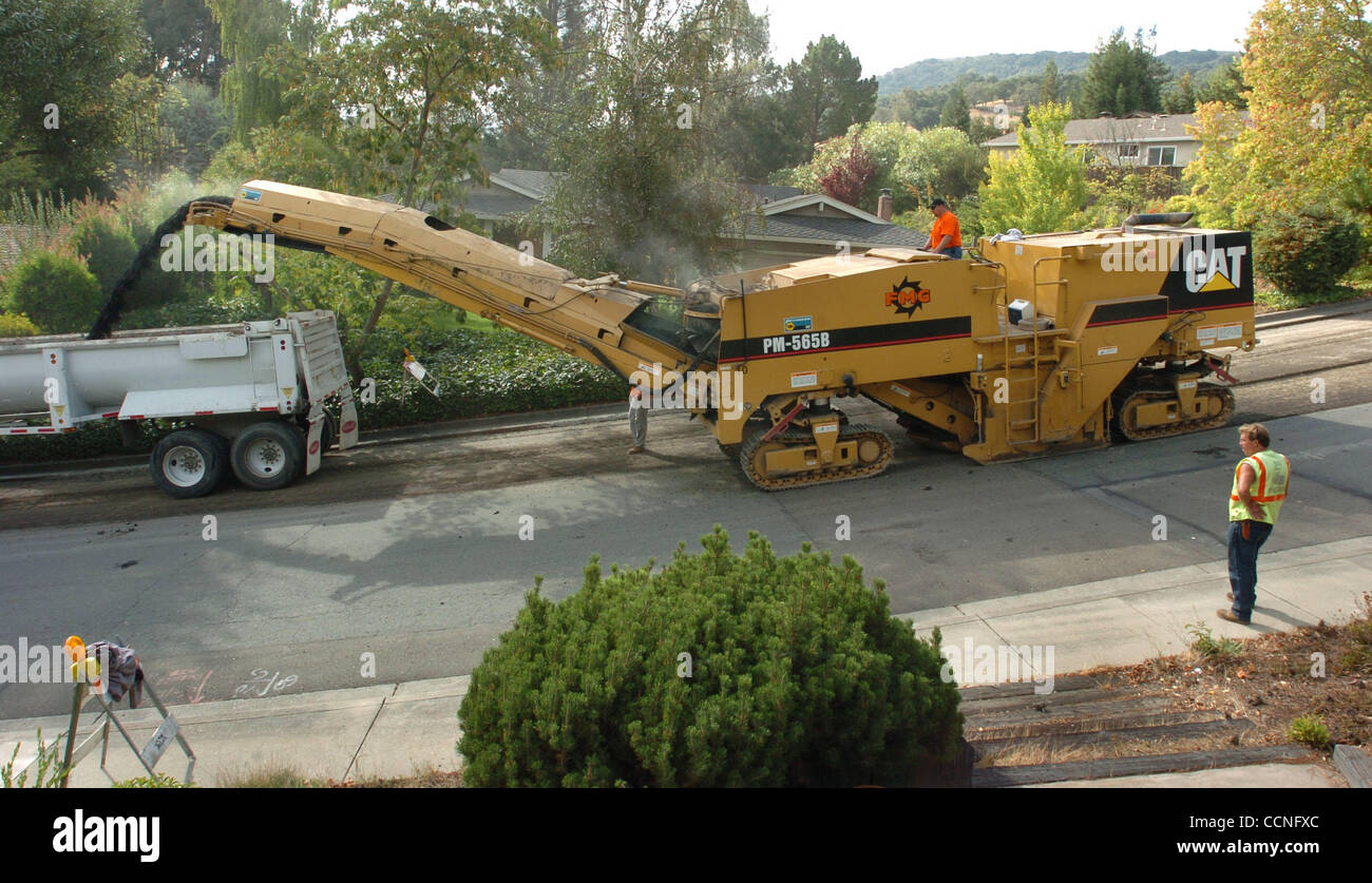 Along Remington Loop an asphalt grinding machine is tearing out the old ...