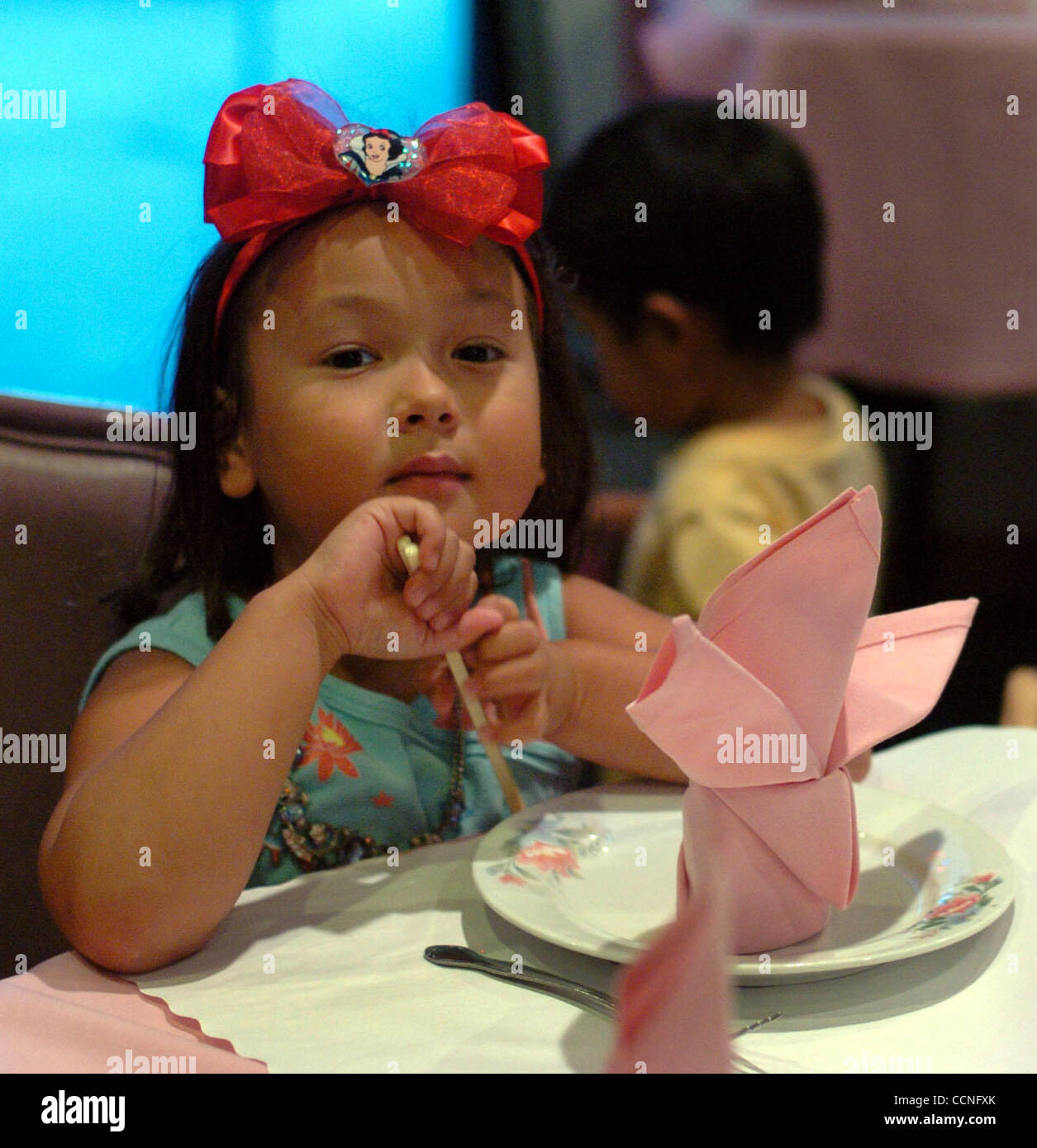Maxine Covello, 5, waits to use her chop sticks at the Pearl Garden ...