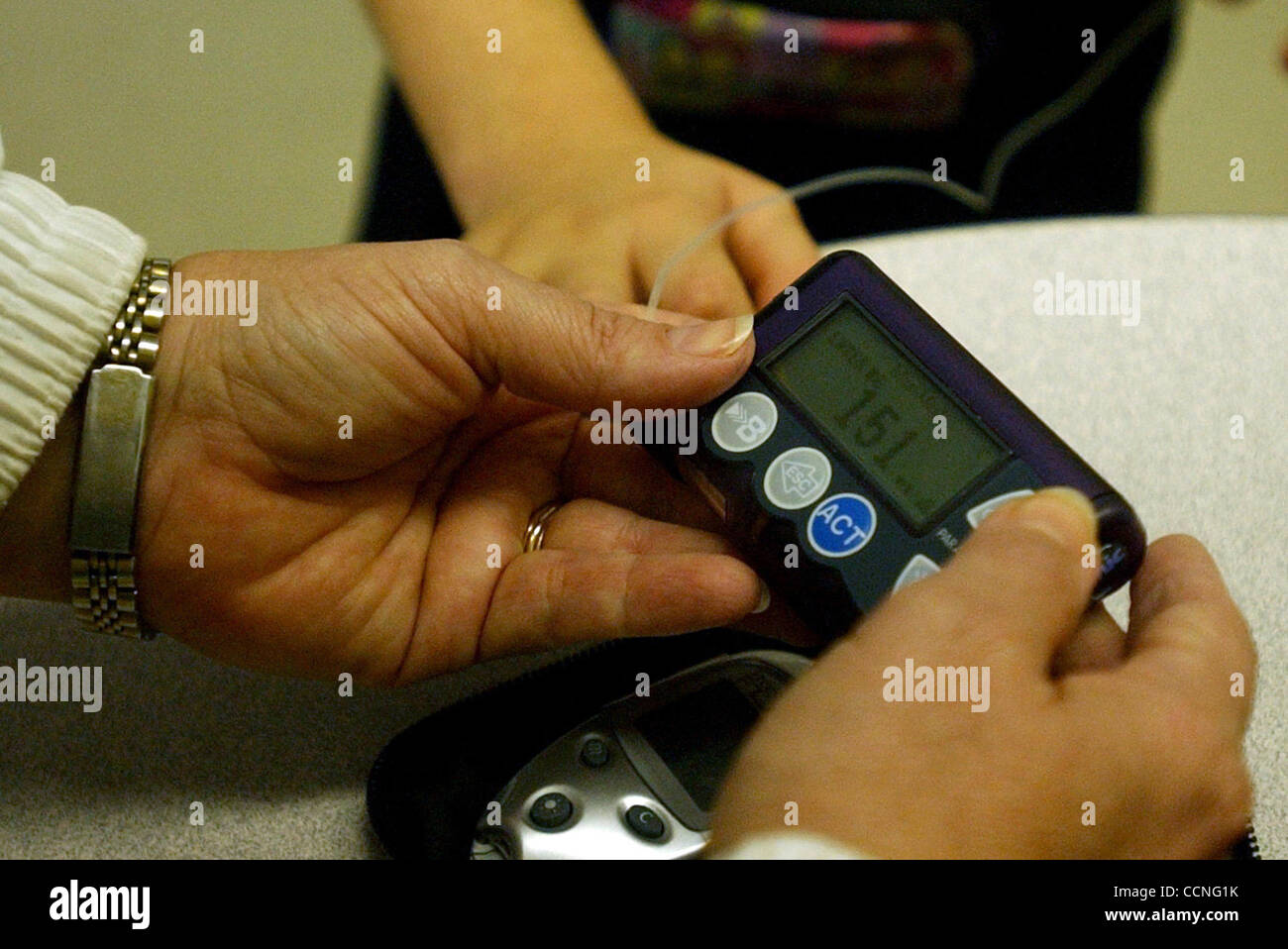 METRO-School nurse Ann Vellom inputs numbers into Kathryn's insulin ...