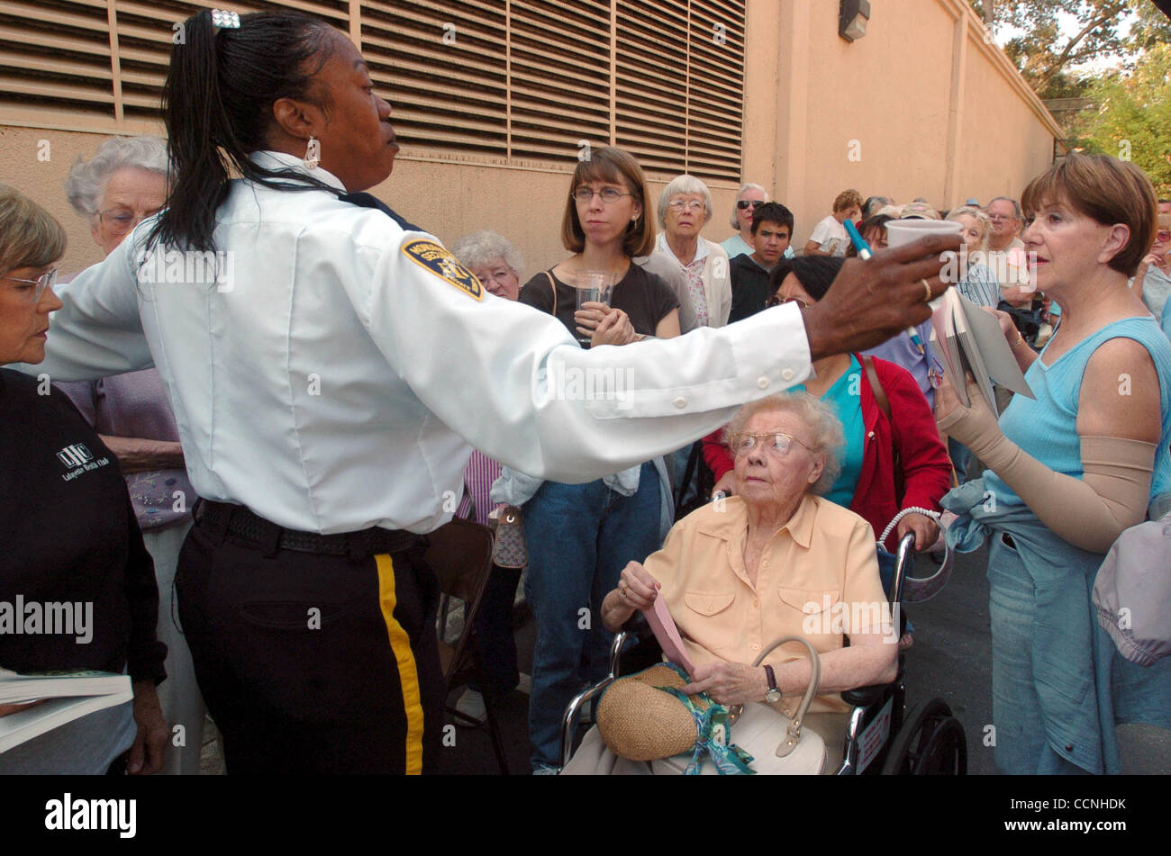 Flores Osborne (in wheel chair) gets the word from Monument Security ...