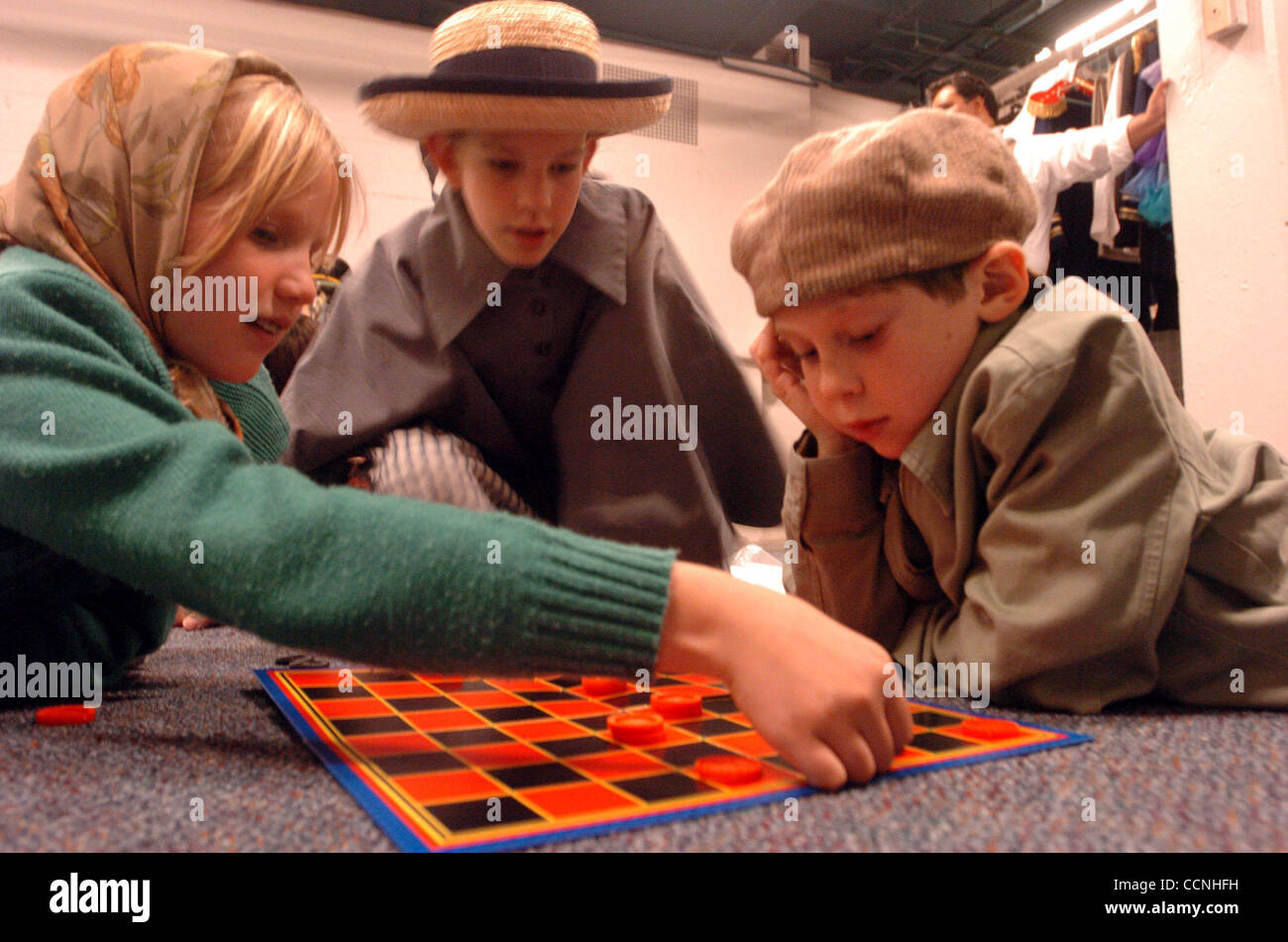 1953--Three young actors pass the time just minutes before taking the ...