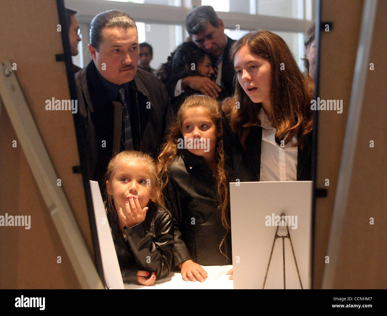 Jessica Foutch (cq)(right) looks at family photos with her uncle Robert ...