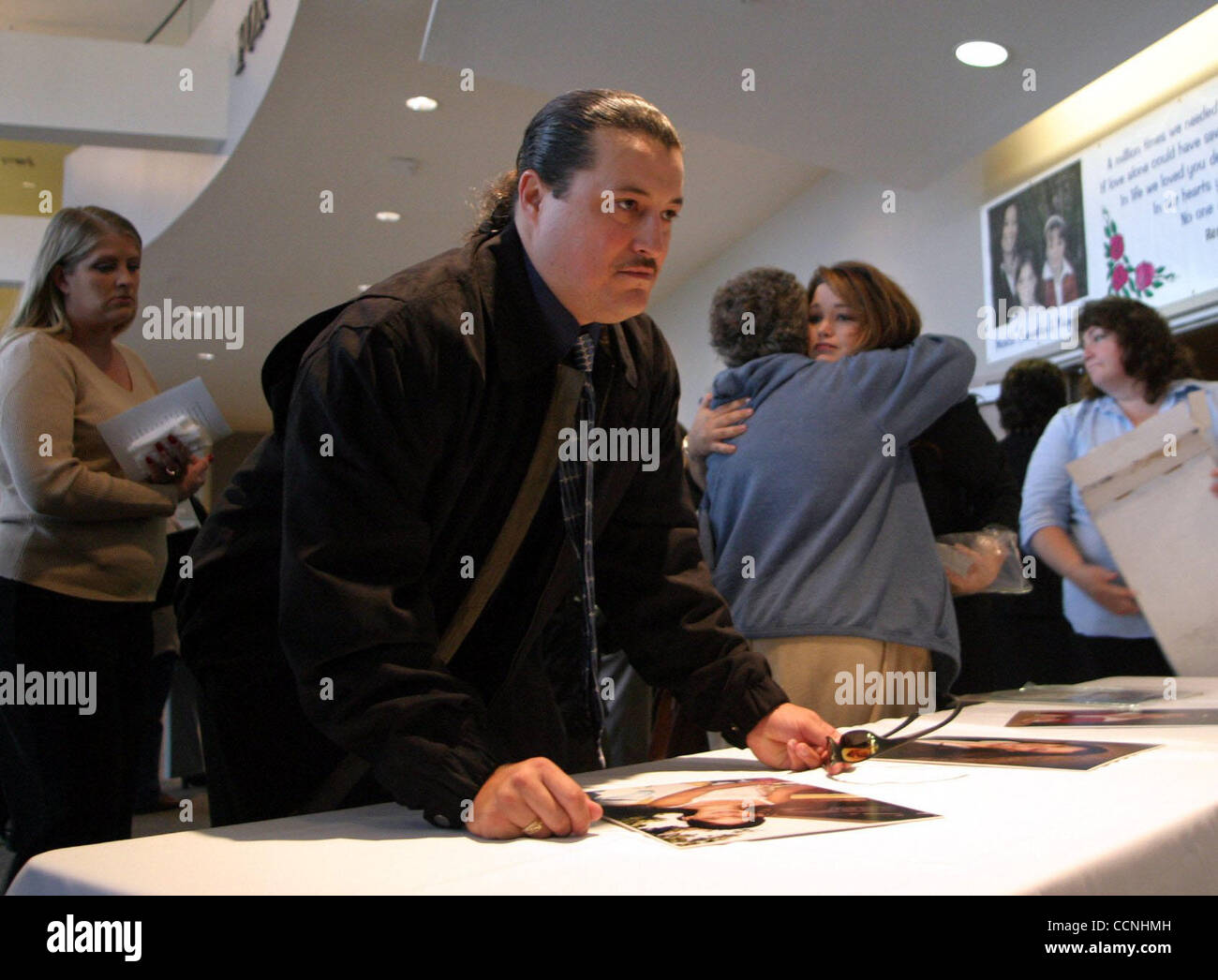 Robert Malabanan jr. (cq) looks at photos of his nieces Samantha Foutch ...