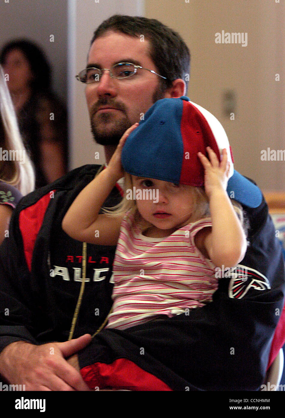 Kali Hurtado (cq)(right) sits with her dad Mark Hurtado (cq), a ...