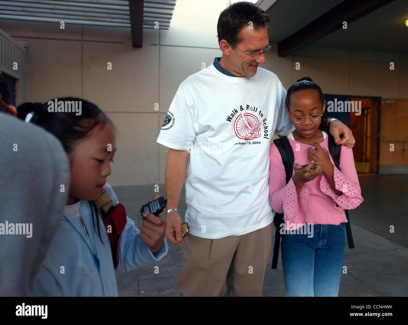 Principal Jeff Knoth listens to Erica Wheat, 9, read about good ...