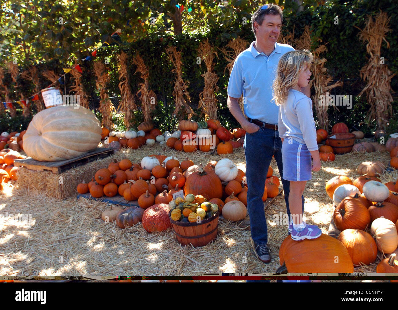 Jeff Rose stands with his daughter Abbey, 5, who stands on a large ...