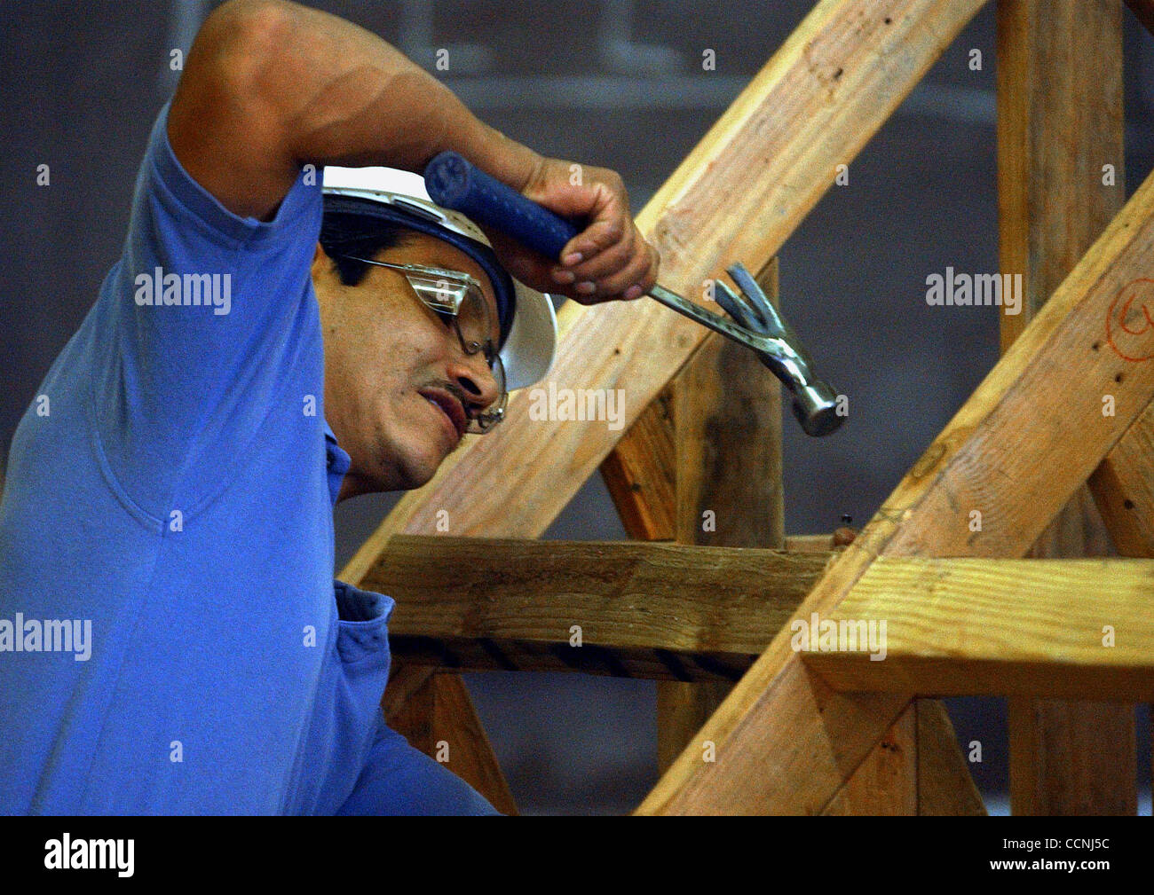 11:08am--Luis Ruiz of Manteca works on a mock up roof at the Carpenters ...