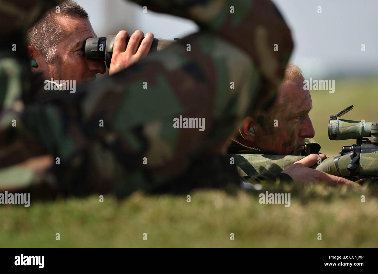 SGT James Martin, left, spots for sniper Corporal Anthony Hague of the ...
