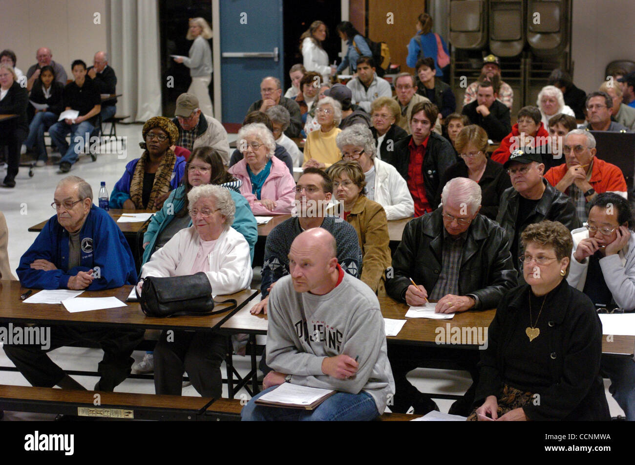 In preparation for election day, poll workers listen to a power point ...