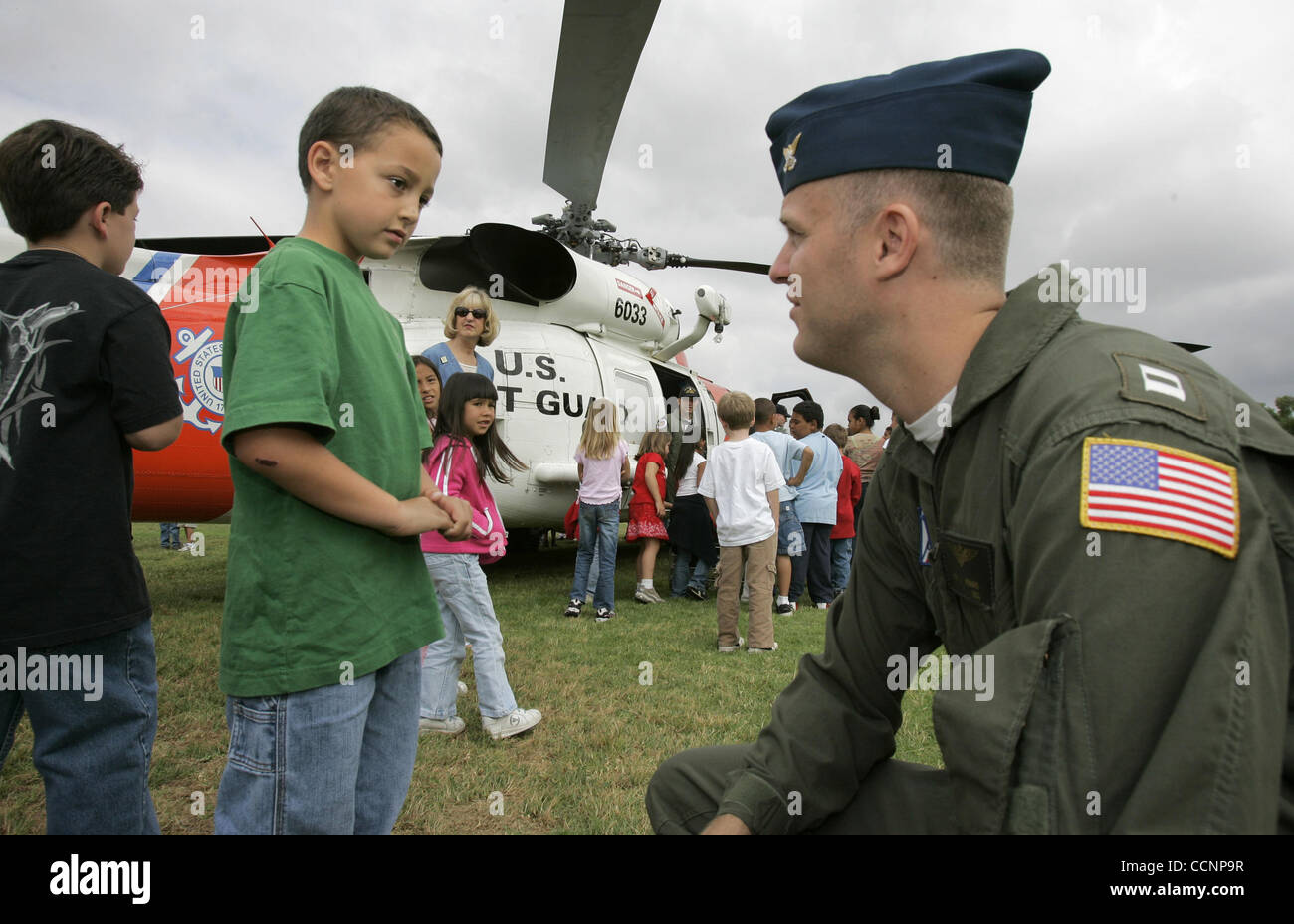 1st. grader GEHRIG ROSEN chats with Coast Guard Lt. DAVID REINHARD, one ...