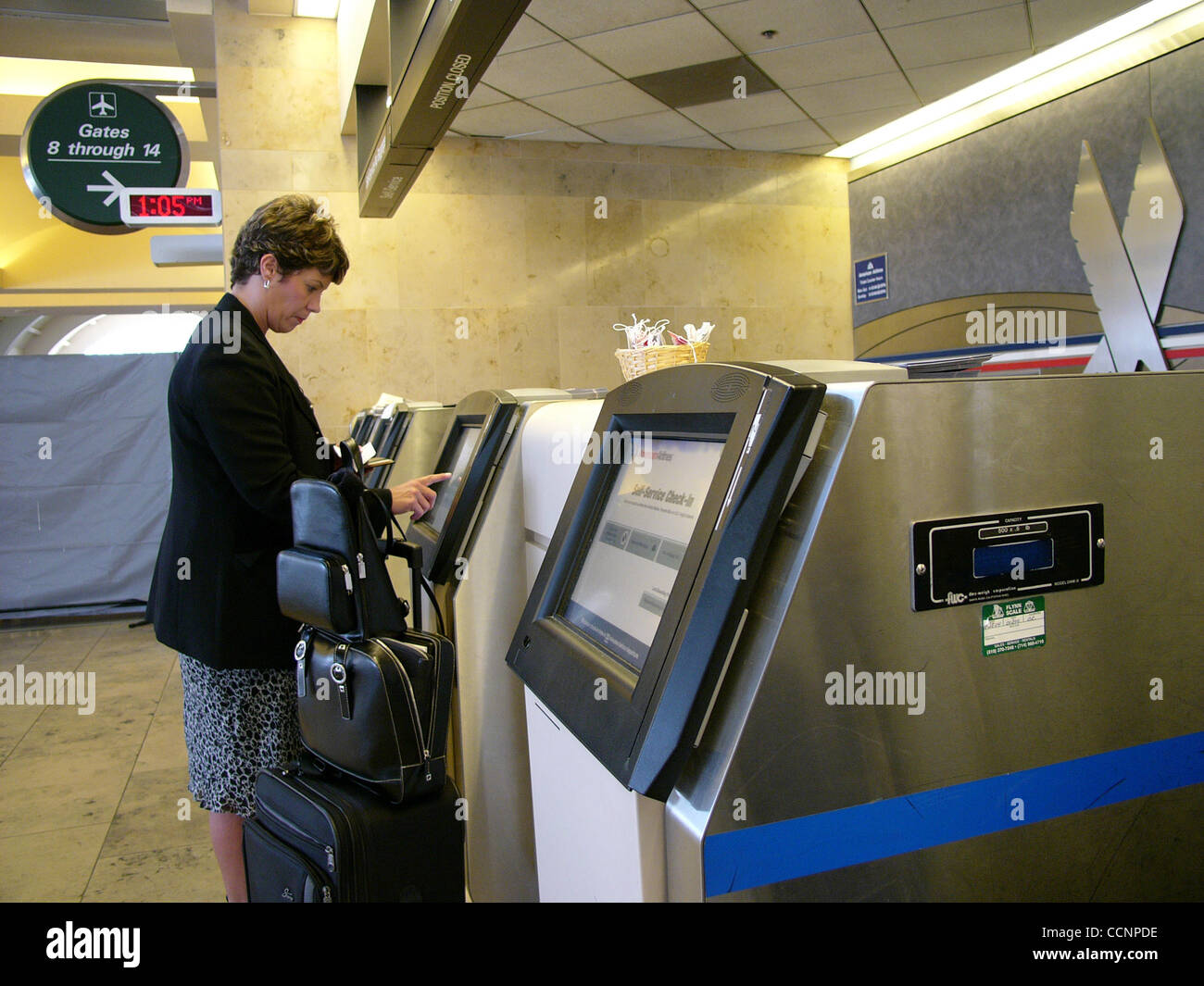 Nov 20, 2004; Santa Ana, CA, USA; A patron with baggage uses a self ...