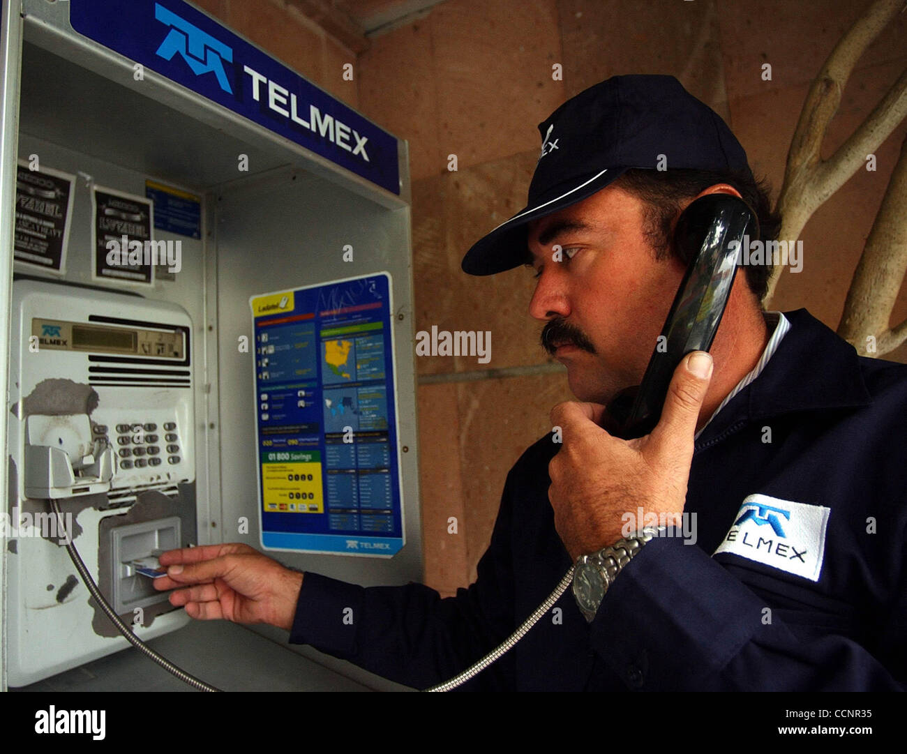 BIZ/ADVANCE/ TELMEX PHONE COMPANY: Telmex tech Jose Omar Garcia inserts ...