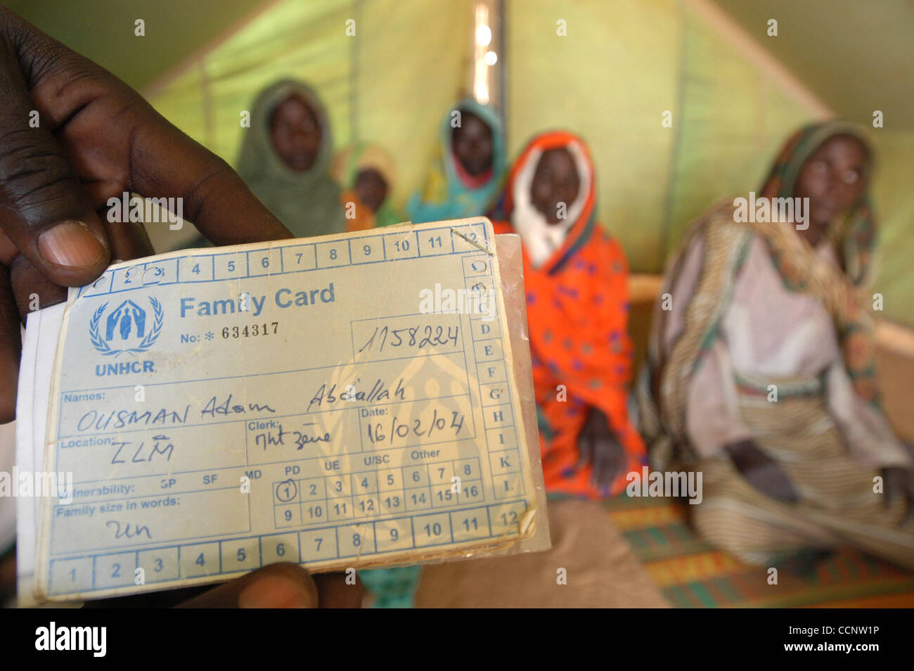 July 16, 2004, Touloum, Chad - A refugee from Darfur shows the ration ...