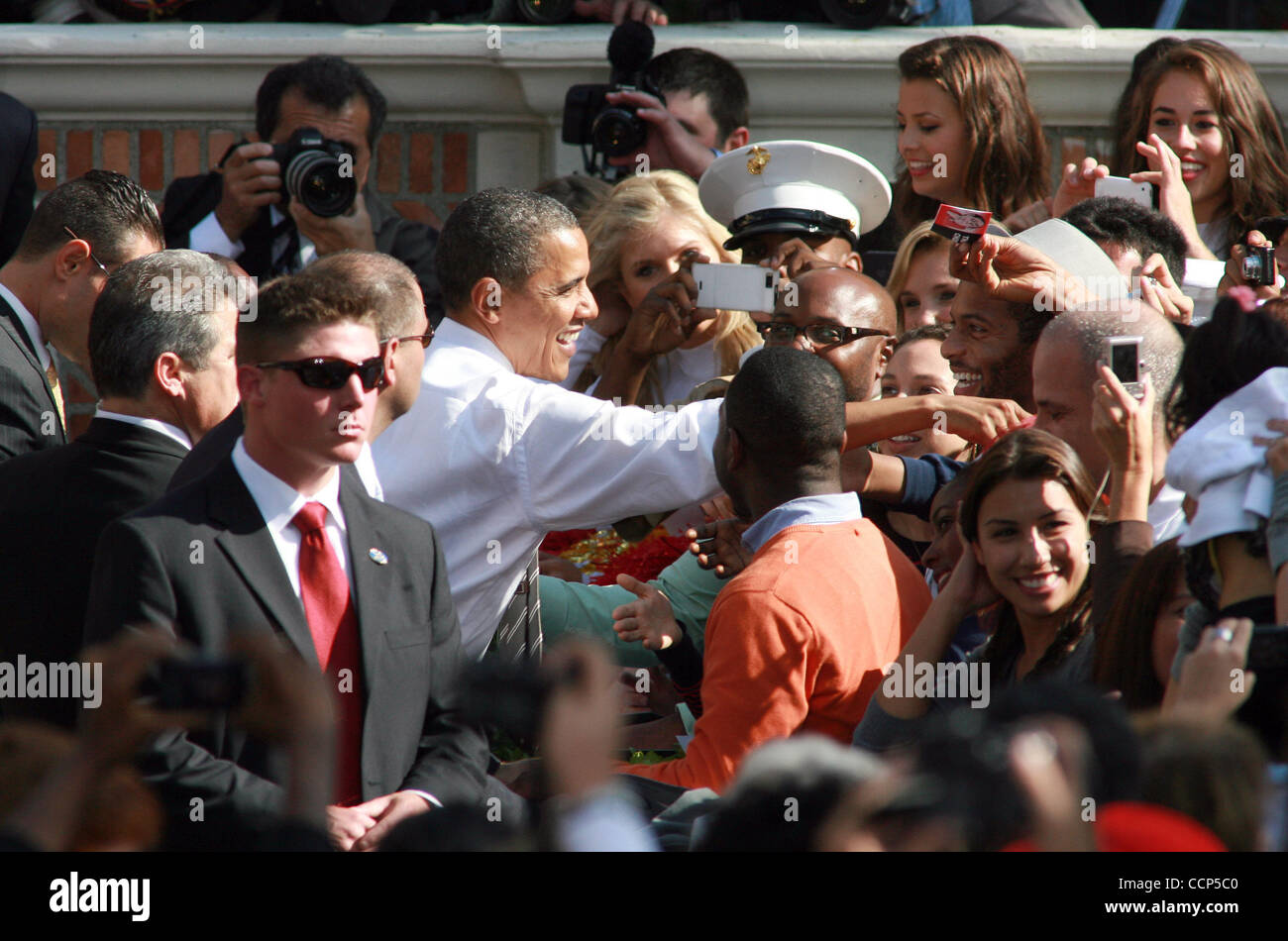 US President Barack Obama shakes hands with people after speaking at a ...