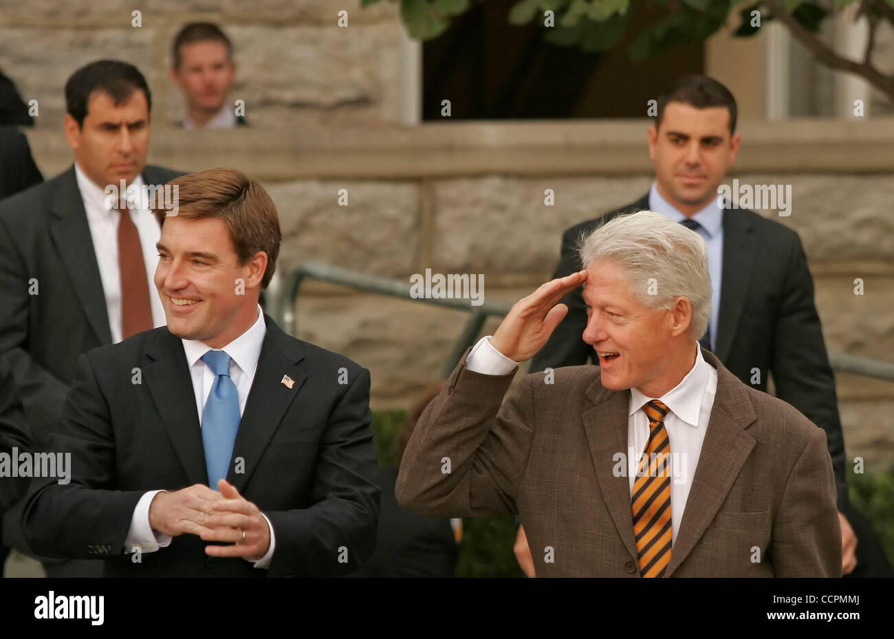 Former President BILL CLINTON (right) salutes the crowd while walking ...