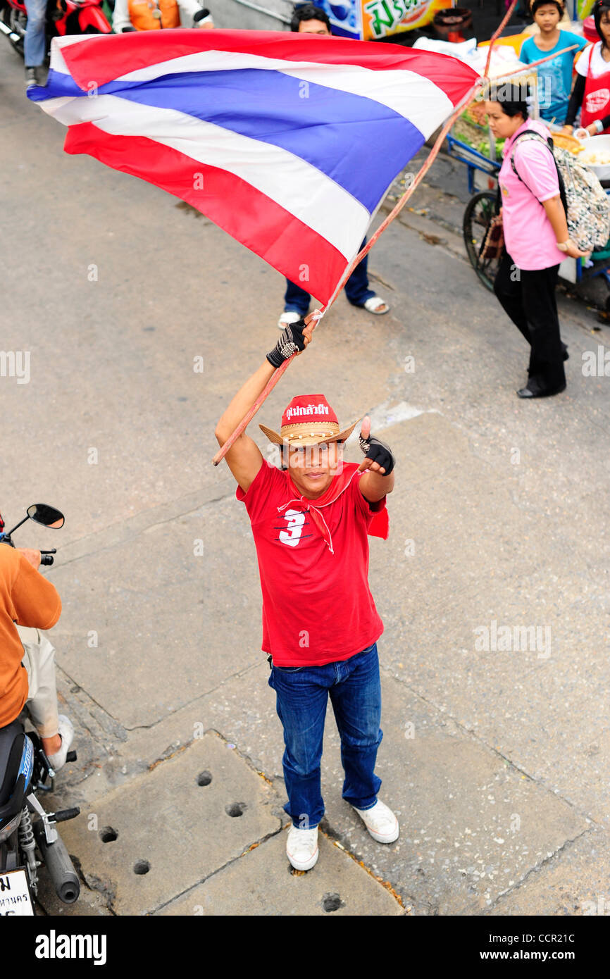Red Shirt, supporter of ousted Prime Minister Thaksin Shinawatra waves ...