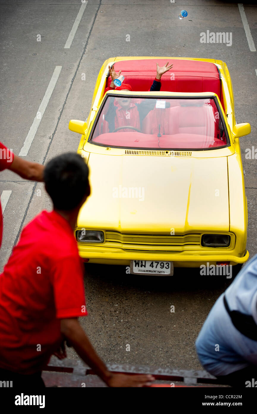 A Red Shirt following the motorcade tries to catch water bottles thrown ...