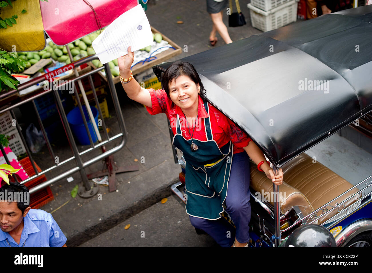 A street Merchant waves at Red Shirts' motorcade. Motorcade carry Red ...