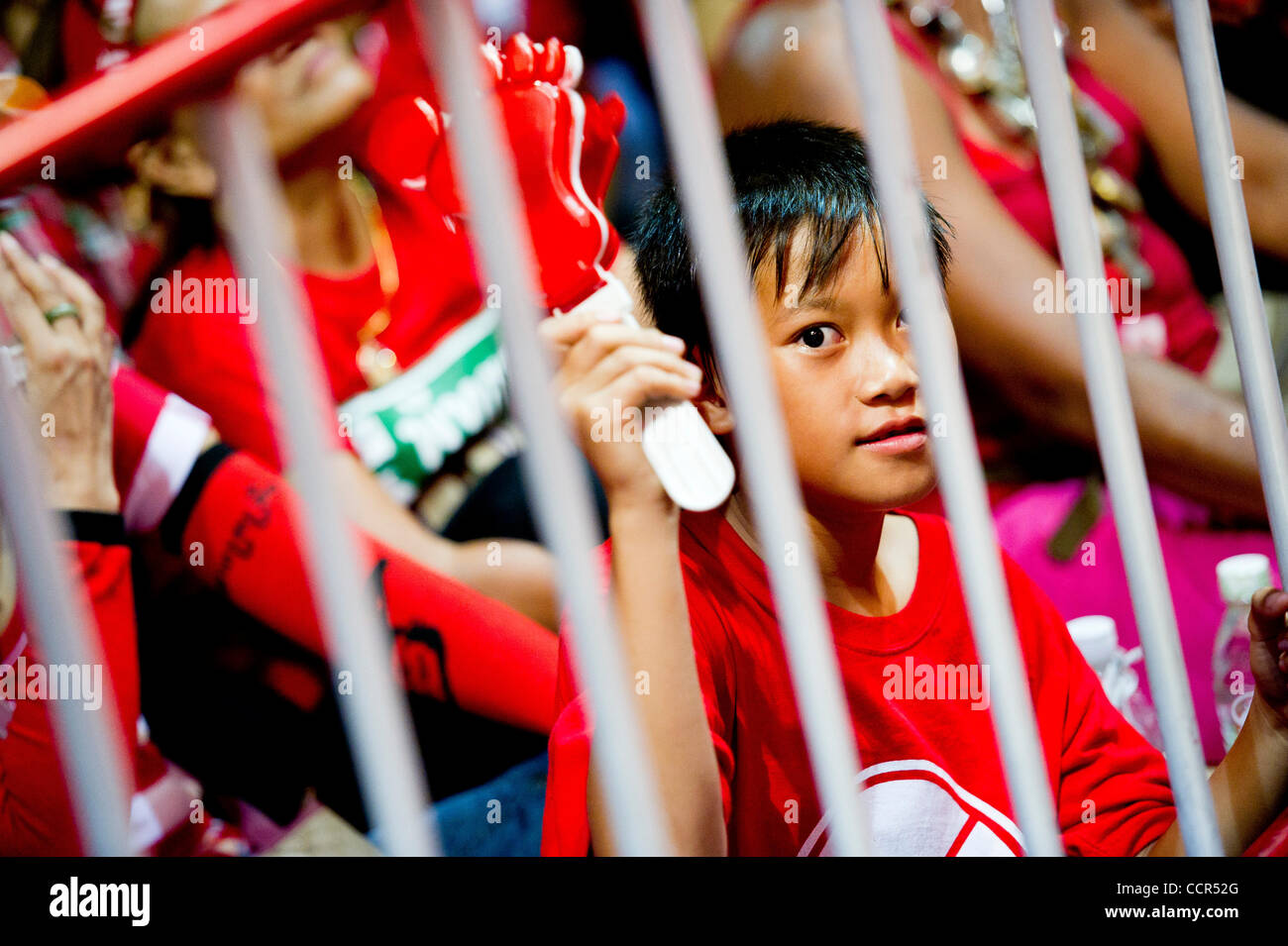 A boy shakes clapper during protest at Ratchaprasong intersection. Red ...