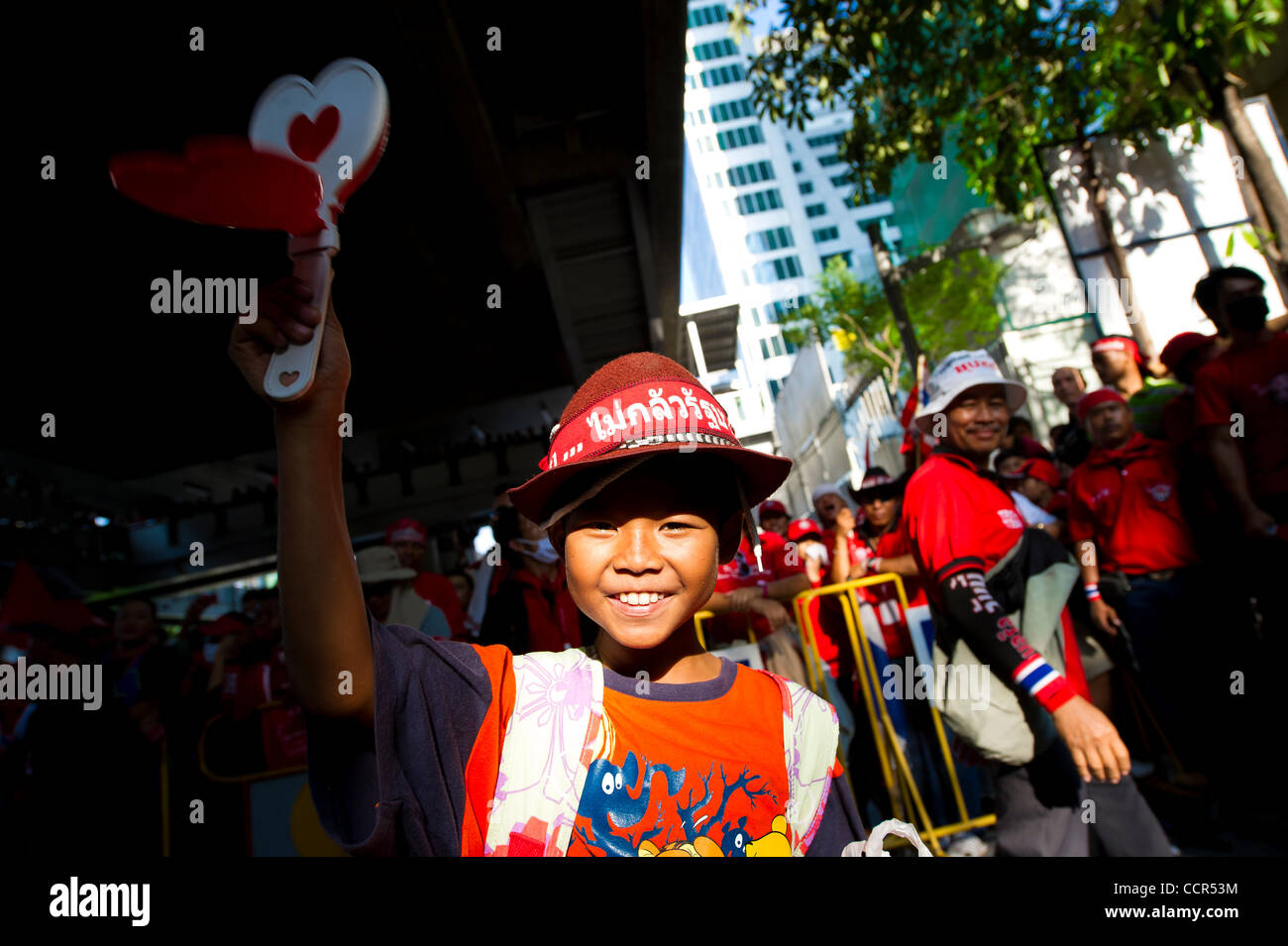 A Red Shirt shakes clapper near protest site in central Bangkok. Red ...