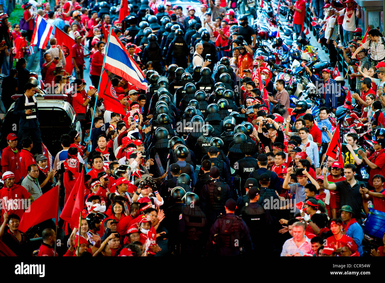 Red Shirts wave and touch hands with police as they leave the protest ...