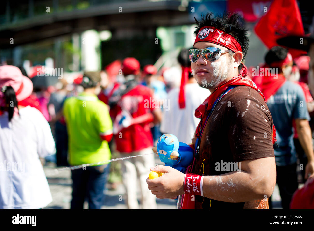 A member of Red Shirts shoot his water gun during the Songkran festival ...