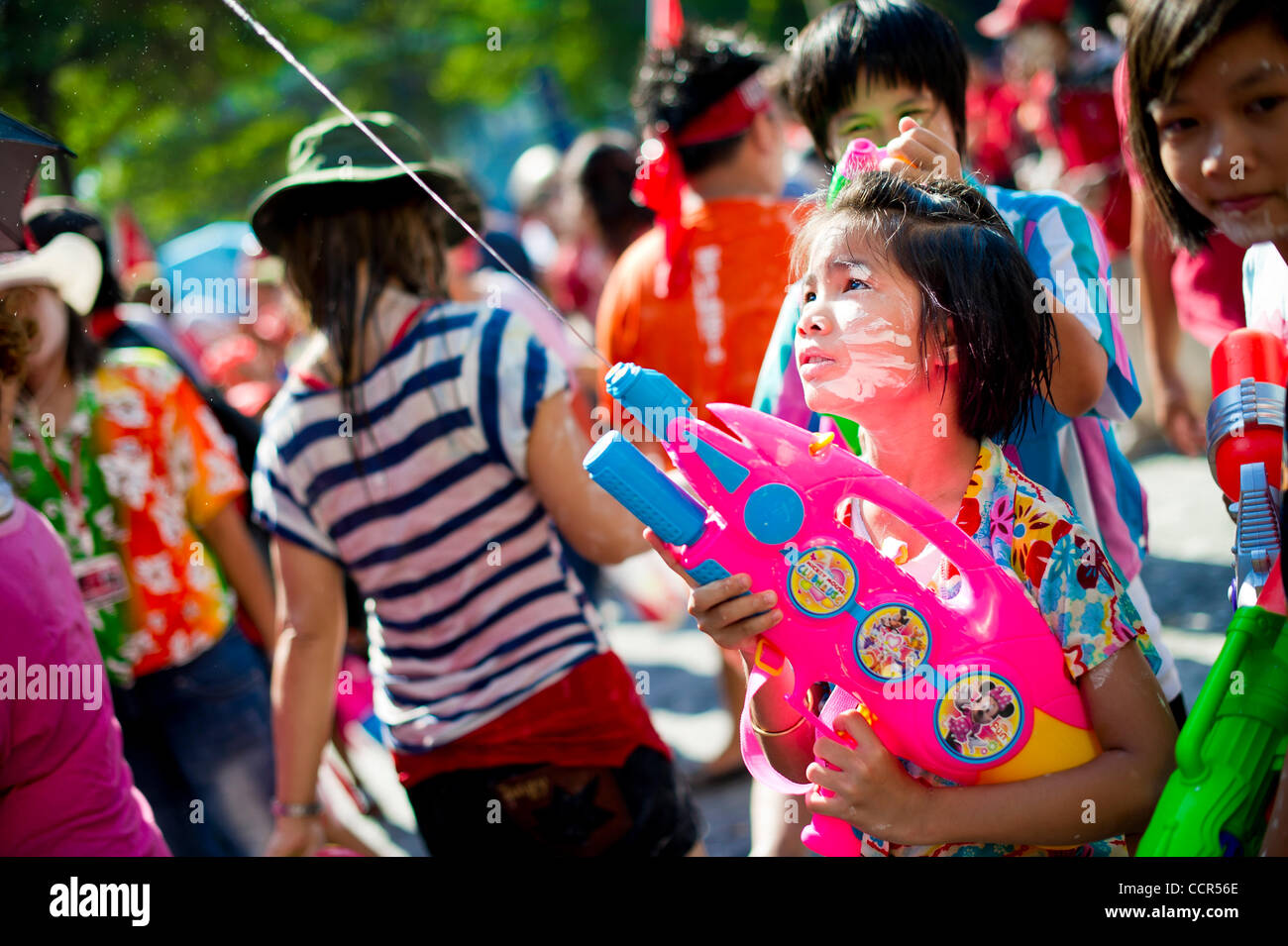 A girl fire her water guns into the air during the Songkran festival at ...