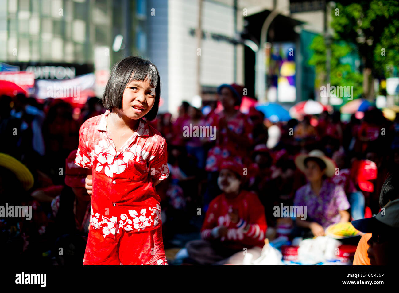 A girl listen to music during Songkran festival at Ratchaprasong ...
