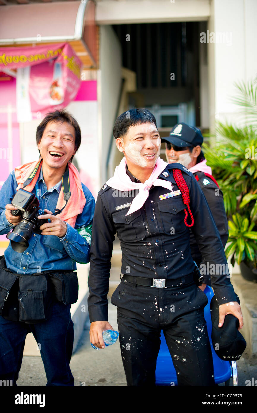 A policement coverd with powder during the Songkran festival at ...