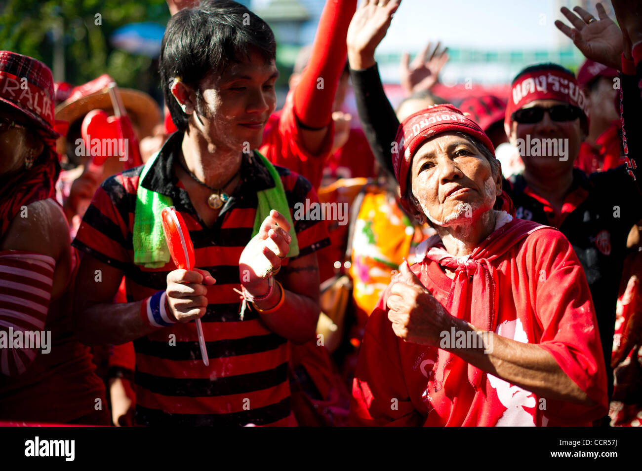 Red Shirts dance in front of UDD's stage during the Songkran festival ...
