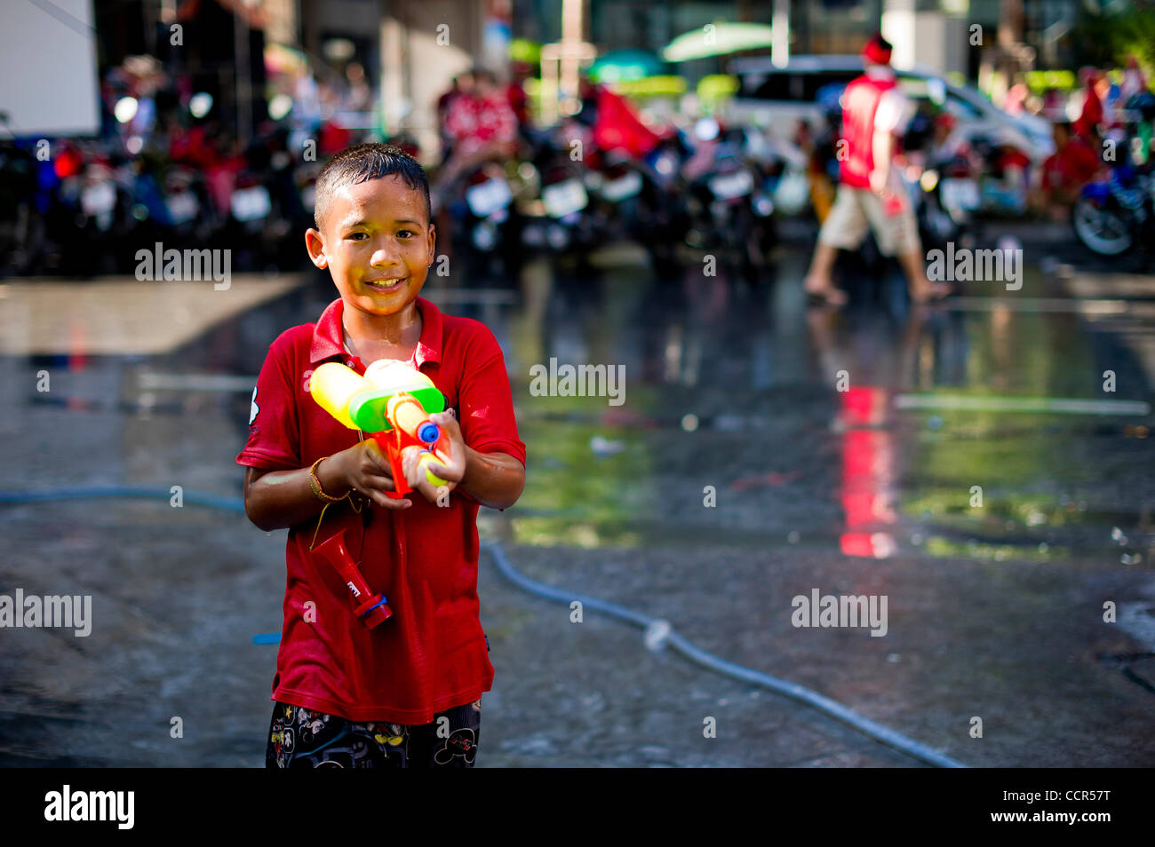A boy with water guns in his hands during the Songkran festival at ...