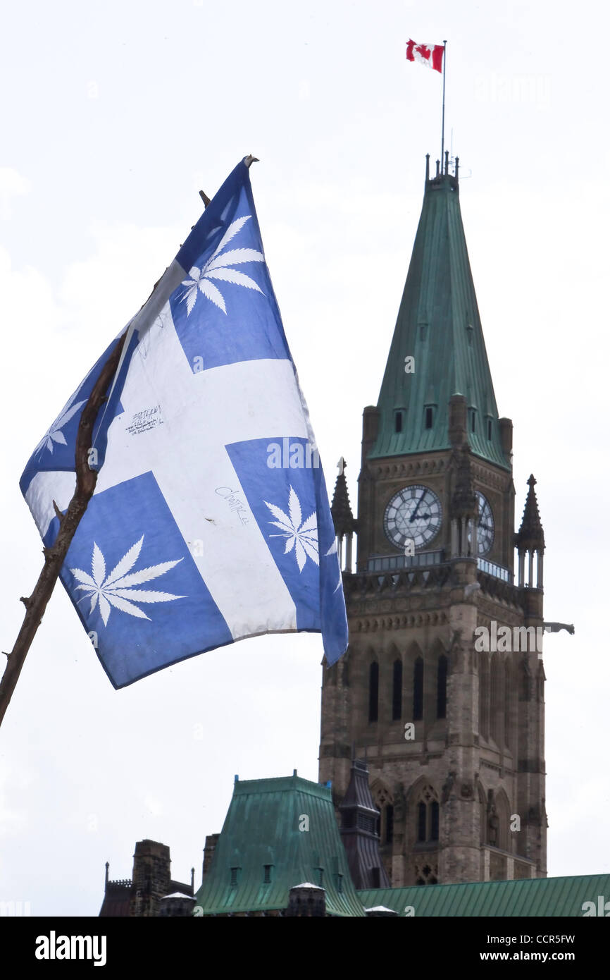 A cannabis flag waves in the wind with the Peace Tower in the ...
