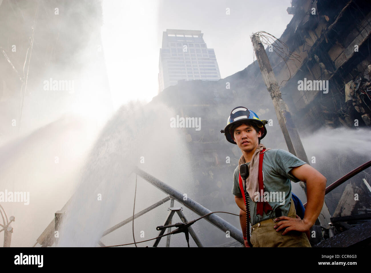 Thai firemen spray water on Central World after it was set ablaze by ...