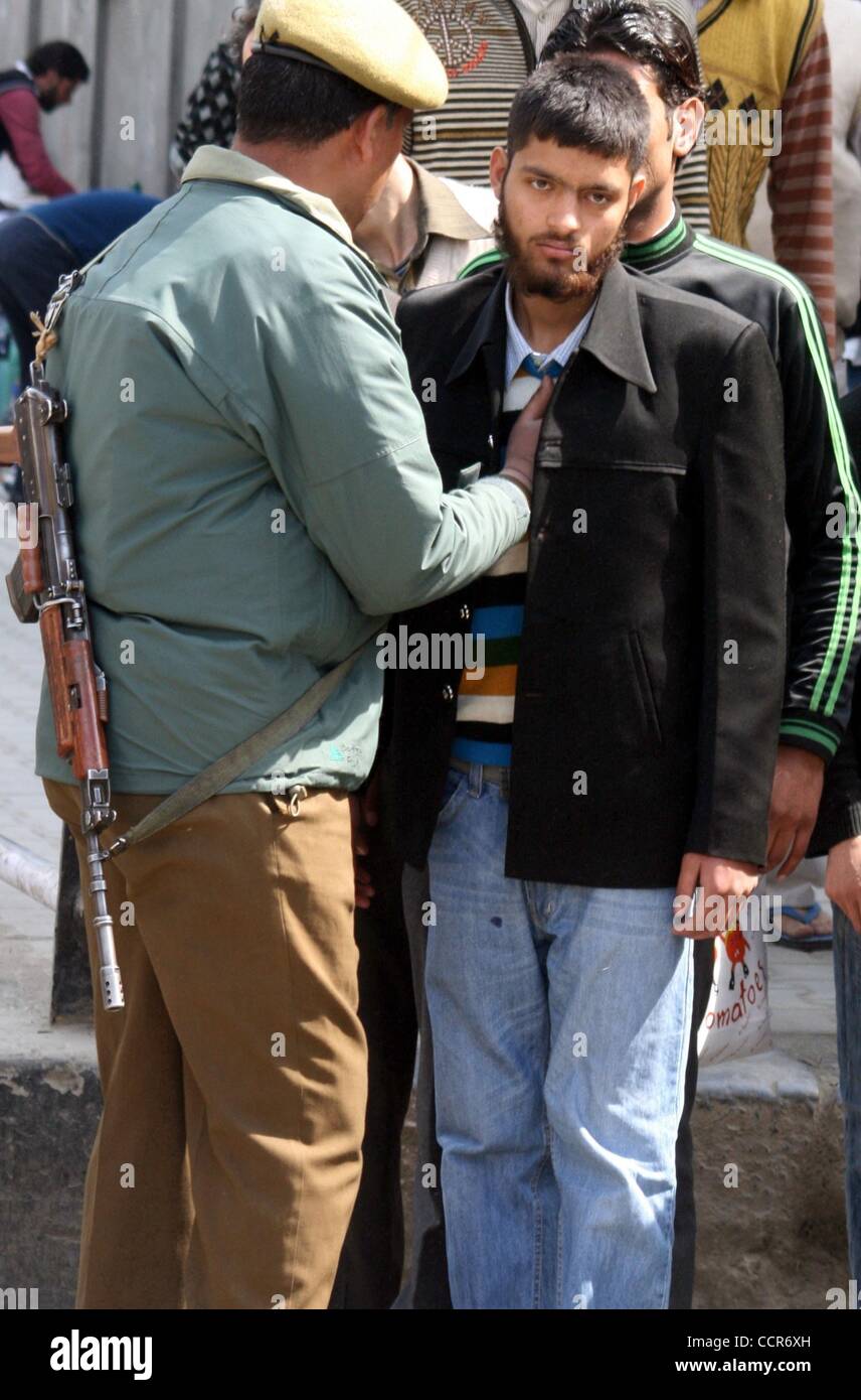 Mar 18, 2010 - Srinagar, Kashmir, India - An Indian policeman checks a Kashmiri Muslim in Lal ...