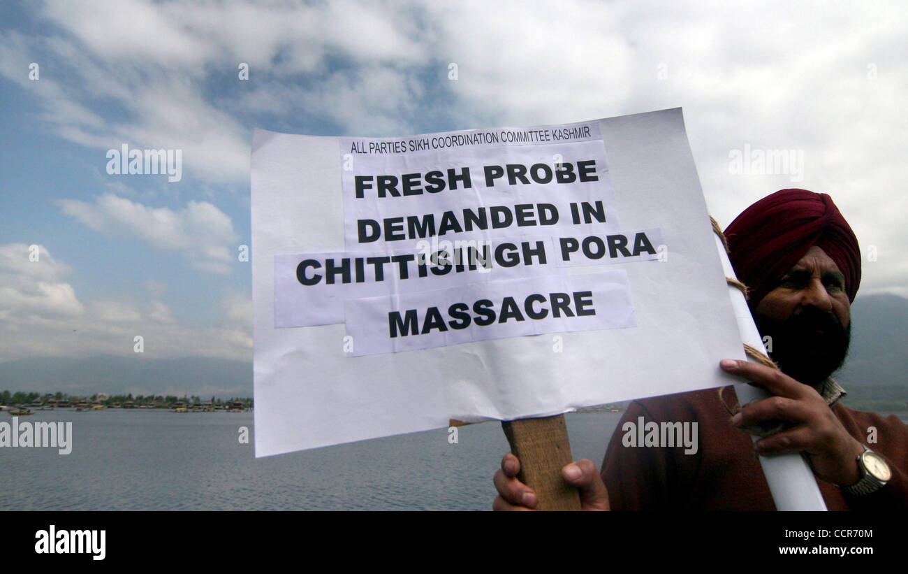 Kashmiri Sikhs holding placards during a demonstration on the banks of ...