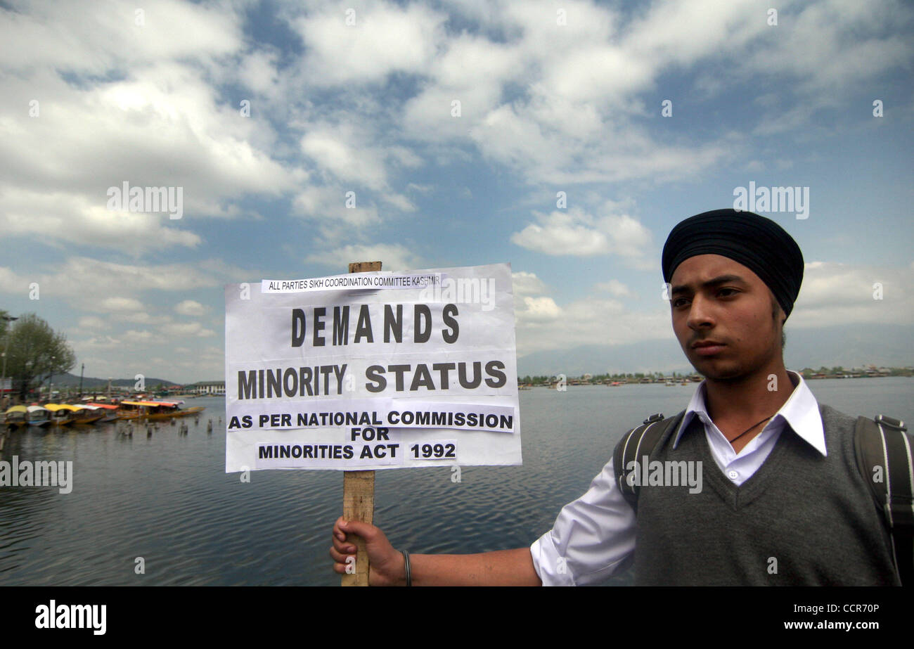 Kashmiri Sikhs holding placards during a demonstration on the banks of ...