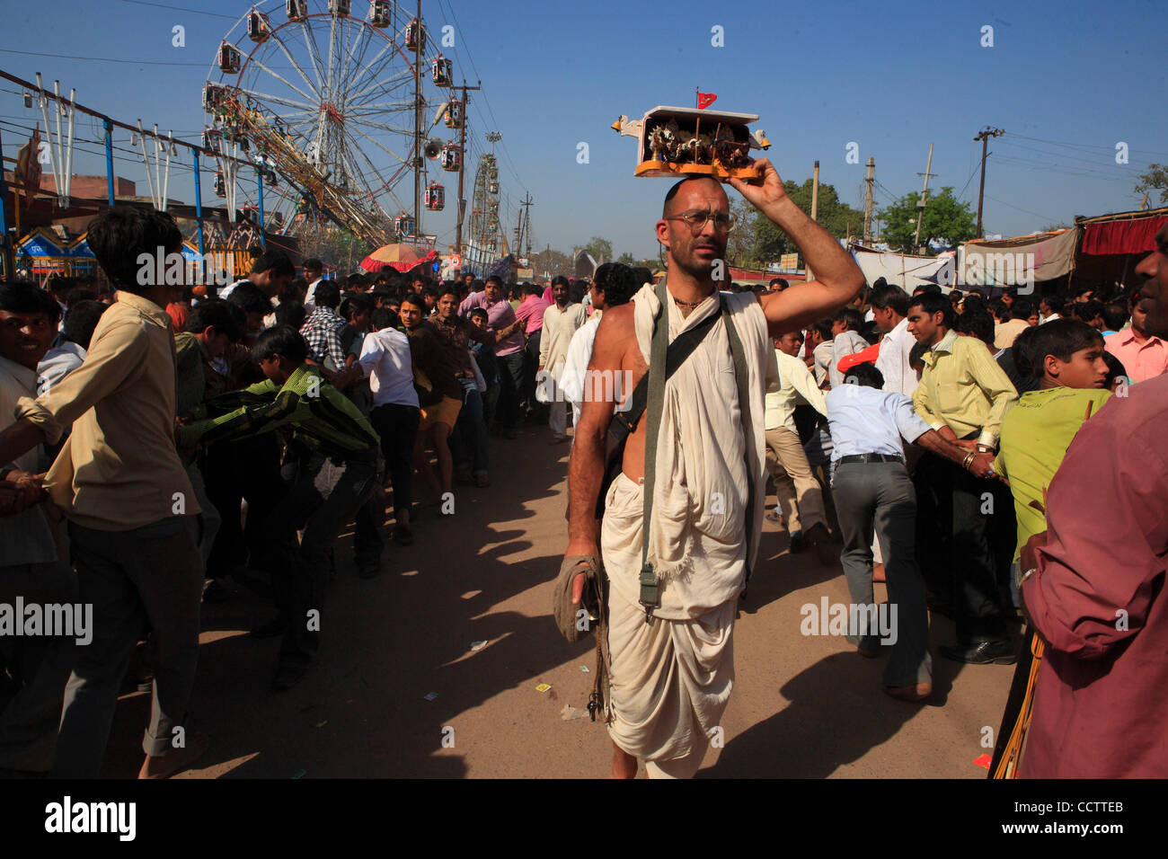 A Krishna devotee participates in a religious procession at Vrindavan ...