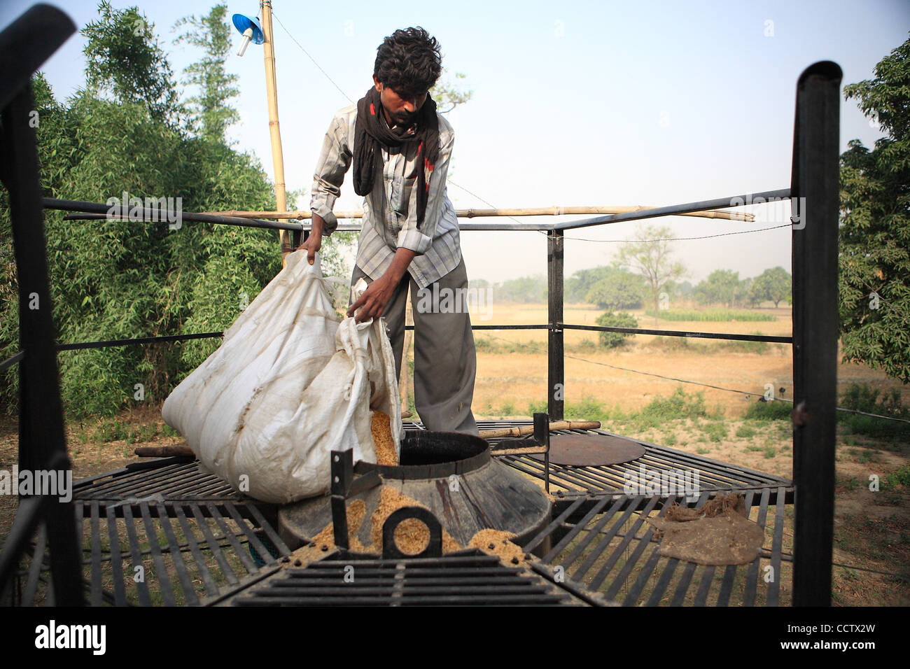 A worker , a local villager trained and employed by Rice Husk Power ...