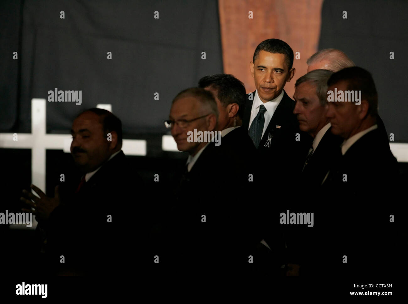 President BARACK OBAMA stands as family members of the fallen Upper Big ...